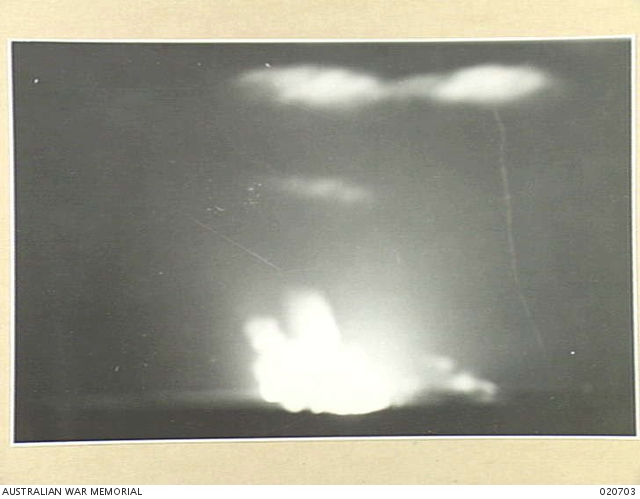 Bombs bursting during a night air raid on Tobruk. | Australian War Memorial
