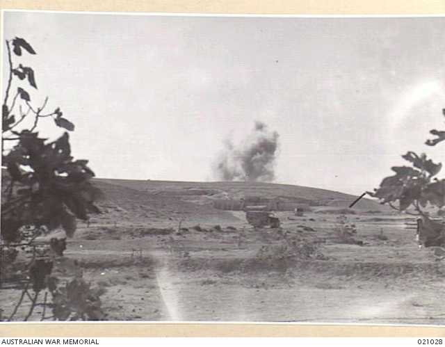 Smoke rising from the explosion of a bomb dropped by an enemy plane ...