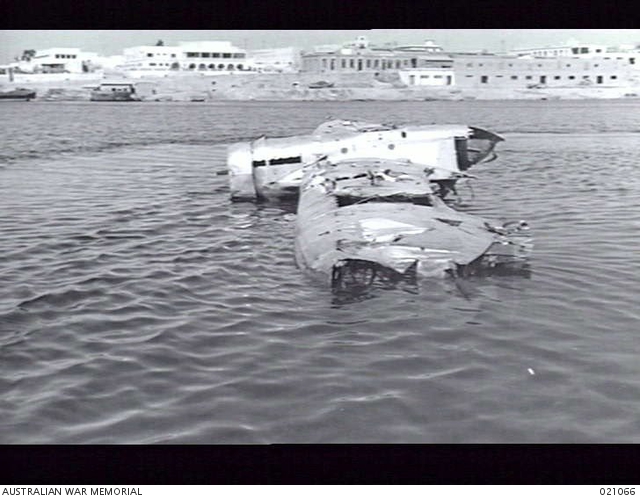 An Italian seaplane brought down during an air battle. Part of Tobruk ...
