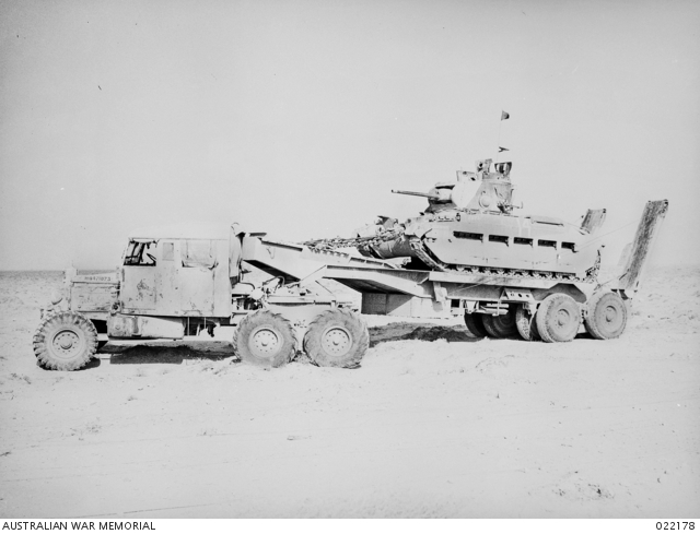 BARDIA, LIBYA. 1941-12. A DAMAGED TANK BEING LOADED ONTO A JINKER FOR ...