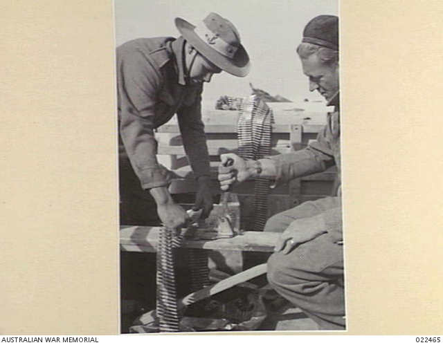 LIBYA. 1941-12. MACHINE GUN BELTS BEING FILLED BEFORE A FLIGHT OF ...