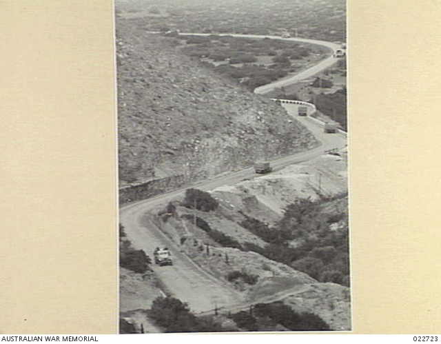 BARCE, LIBYA. 1942-01. A CONVOY OF TRUCKS NEGOTIATING A PASS THROUGH ...