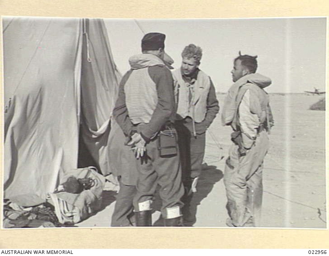 LIBYA. 1942-01-02. PILOTS OF NO. 3 SQUADRON RAAF DISCUSSING OPERATIONAL ...
