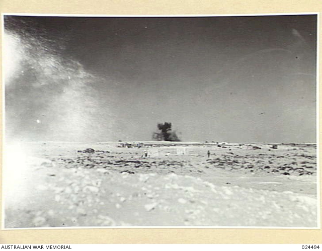 SHELL BURST FROM GERMAN ARTILLERY ON THE ROAD ABOVE EL ALAMEIN STATION ...