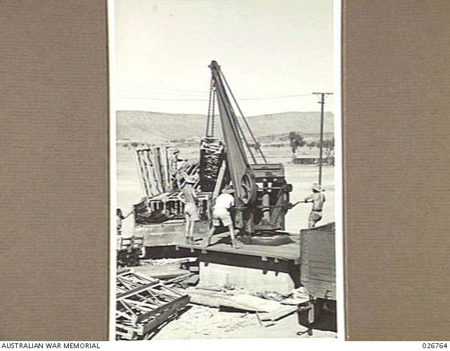 ALICE SPRINGS, NT. 1942-09-28. MEMBERS OF THE RAAF UNLOADING GIRDERS BY ...