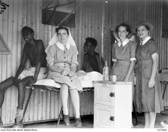 Informal portrait of two Aboriginal patients with nurses outside No 1 ...