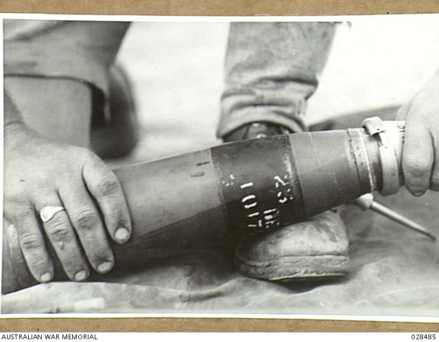 SINGLETON, AUSTRALIA. 1943-01. HANDLING A GAS-SHELL DURING AN ...
