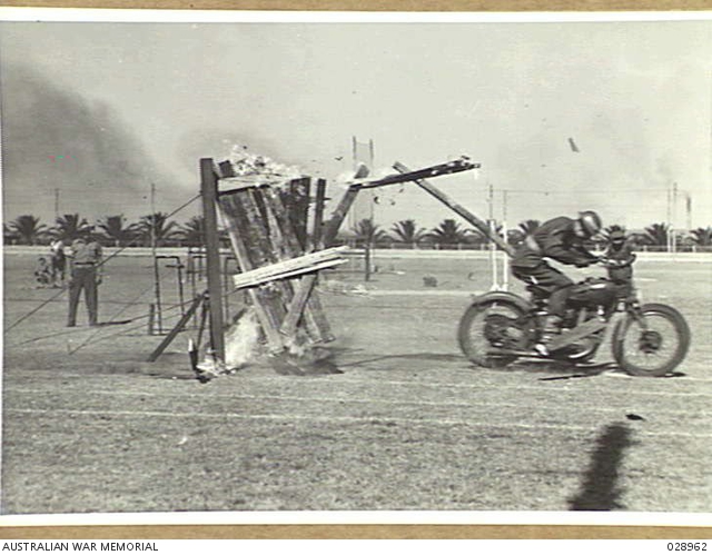 PERTH, AUSTRALIA. 1943-01-16. AN ARMY DESPATCH RIDER CRASHING THROUGH A ...