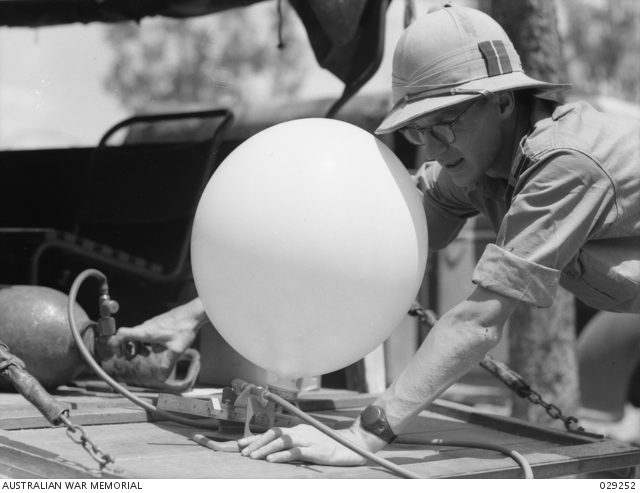 TOWNSVILLE, QLD. 1942-11. FLYING OFFICER TAYLOR, OF THE RAAF, FILLING ...