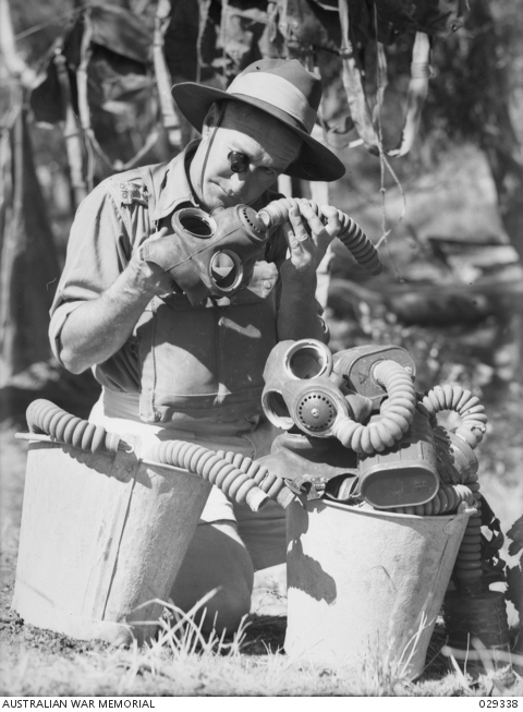 FORBES, AUSTRALIA. 1943-02. CAPTAIN G.S. COMPTON EXAMINING RESPIRATORS ...