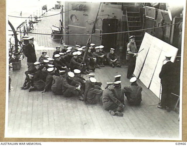 HMAS AUSTRALIA, AT SEA. 1943-02. LIEUTENANT-COMMANDER J. DENNY SPEAKING ...
