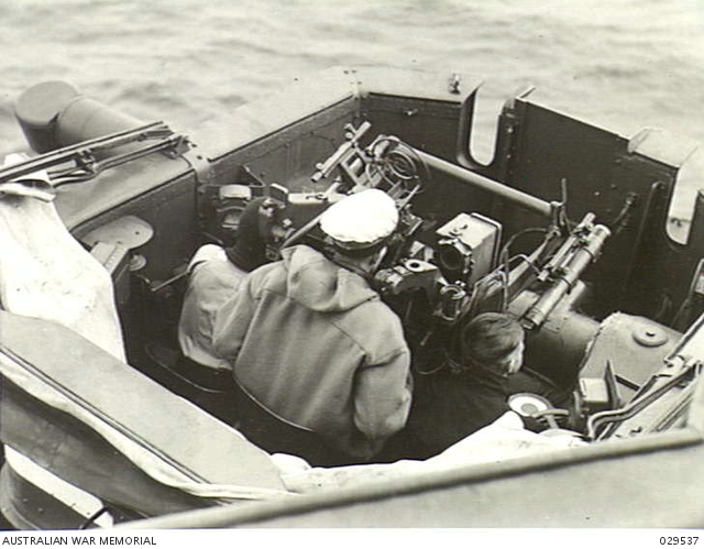 HMAS AUSTRALIA, AT SEA. 1943-02. THE CREW OF THE 4-INCH HIGH ANGLE ...