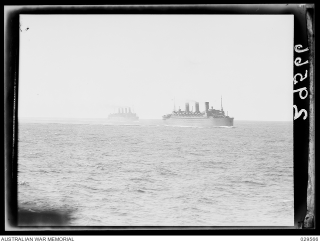 HMAS AUSTRALIA, AT SEA. 1943-02. TWO OF THE SHIPS OF THE CONVOY ...
