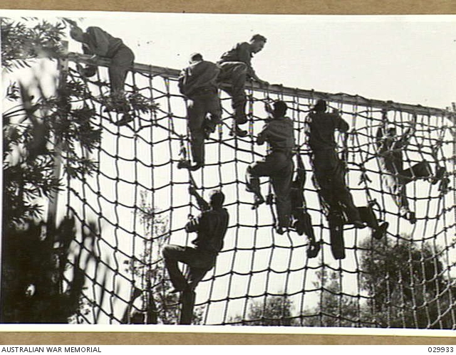FRANKSTON, AUSTRALIA. 1943-03-30. THE CLIMBING UP AND DOWN A ROPE ...