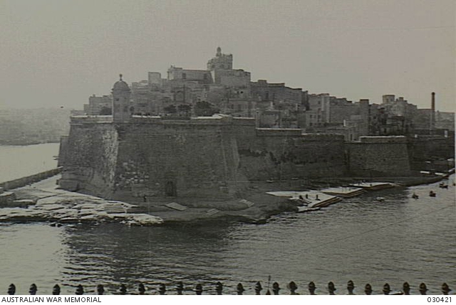 Fortification at the entrance to the harbour. The backs of the heads of ...
