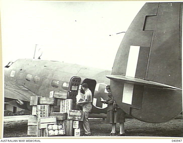 Brisbane, Qld. 1944-09. Fresh vegetables and fruit being loaded on to a ...