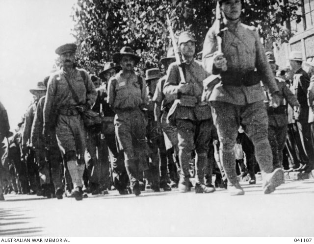 A column of British and Australian prisoners of war marching through ...