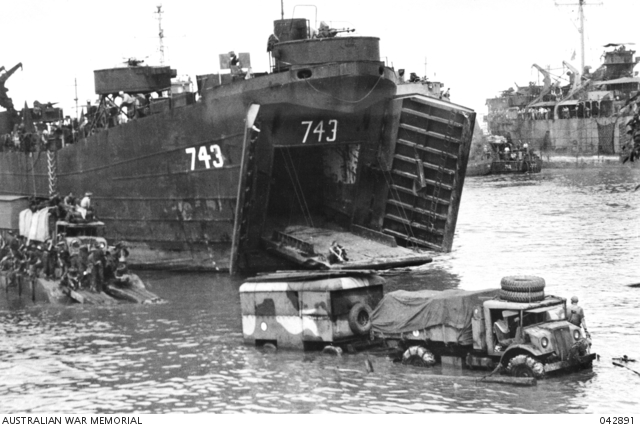 Tarakan, Borneo. 1945-05. Trucks coming off the Landing Ship, Tanks ...