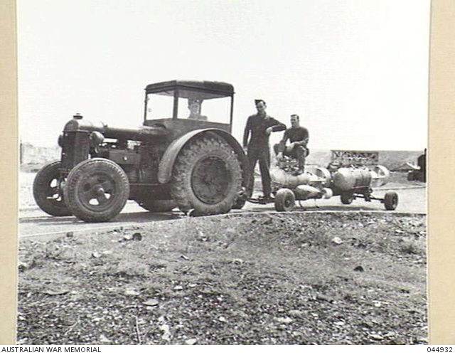 DEPTH CHARGES BEING TRANSFERRED FROM A BOMB DUMP TO QUAYSIDE WHERE THEY ...