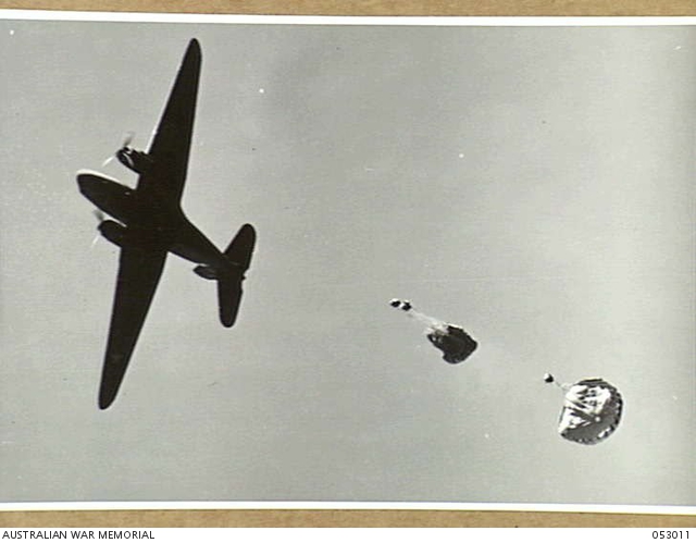 PARACHUTES OPEN AS THEY LEAVE THE AIRCRAFT CARRYING FOOD RATIONS DURING ...