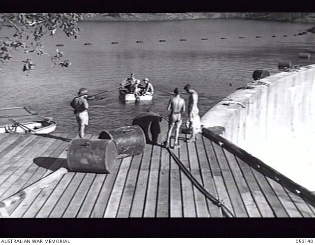 DARWIN, NT. 1943-07-01. CONNECTING "JACK STAY" TO FLOTATION BARRELS ON ...