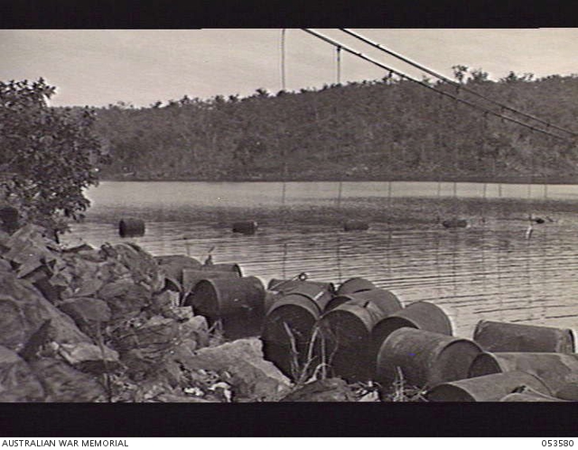 DARWIN, NT. 1943-07-10. FLOTATION BARRELS MOORED ON THE EDGE OF MANTON ...