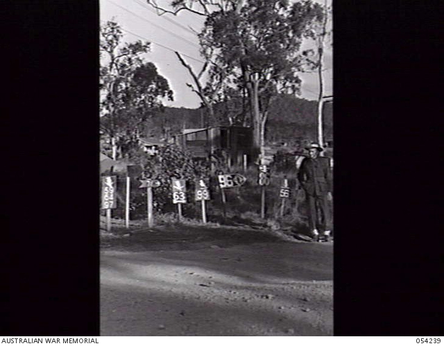 RAVENSHOE, QLD. 1943-07-14. UNIT SIGNPOSTS IN THE 7TH AUSTRALIAN ...
