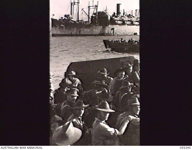 CAIRNS, QLD. 1943-08-08. BARGES FILLED WITH TROOPS OF THE 9TH ...
