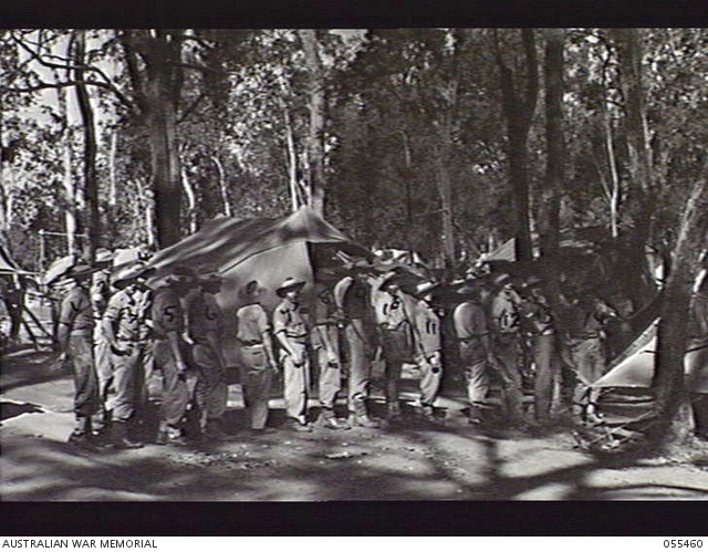 HERBERTON, QLD. 1943-08-11. PAY PARADE AT HEADQUARTERS, 6TH AUSTRALIAN ...