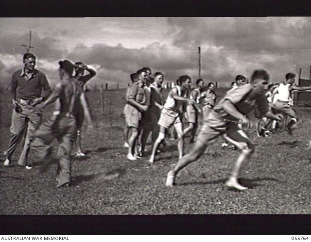 YUNGABURRA, QLD. 1943-08-16. RUNNERS CHANGING FLAGS IN A RELAY RACE AT ...