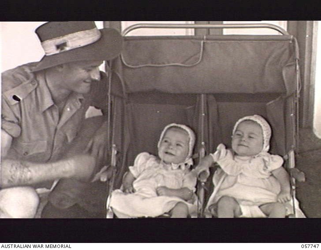 CAIRNS, QLD. 1943-09-19. WX7691 GUNNER A. H. CHAPPEL ADMIRES THE TWINS ...