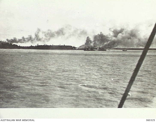 DARWIN, AUS. 1942-02-19. VIEW OF THE WATERFRONT FROM A SHIP IN THE ...