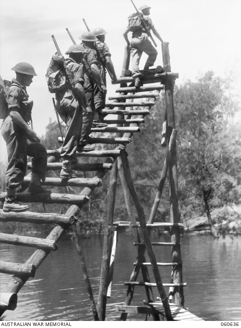 CANUNGRA, QLD. 1943-11-25. TROOPS JUMPING OFF A 20 FOOT HIGH PLATFORM ...