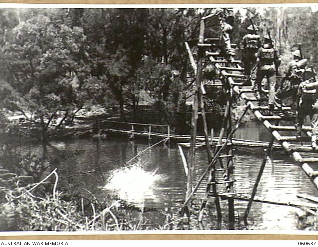 CANUNGRA, QLD. 1943-11-25. TROOPS JUMPING OFF A 20 FOOT HIGH PLATFORM ...