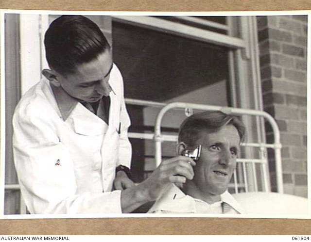 PERTH, WA. 1943-12-17. CORPORAL C. SMITH (2) BARBER AT THE 110TH ...