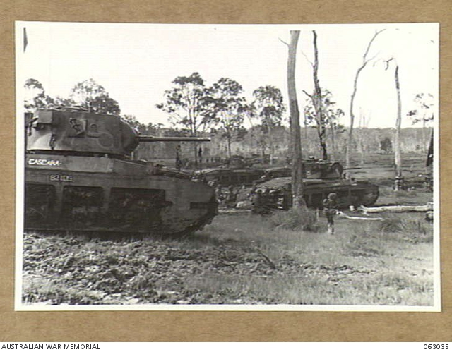 COOMERA, QLD. 1944-01-10. TROOPS ADVANCING UNDERCOVER OF MATILDA TANKS ...