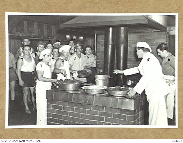 HAY, NSW. 1944-01-16. COOKS AND STAFF AT WORK IN ONE OF THE KITCHENS OF ...