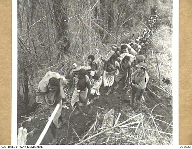 SHAGGY RIDGE, NEW GUINEA. 1944-01-20. NATIVE CARRIERS ARRIVING AT THE ...