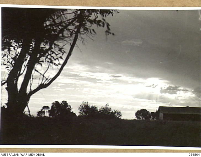 BARMERA, SOUTH AUSTRALIA. 1943-03. SUNSET OVER THE HEADQUARTERS OF THE ...