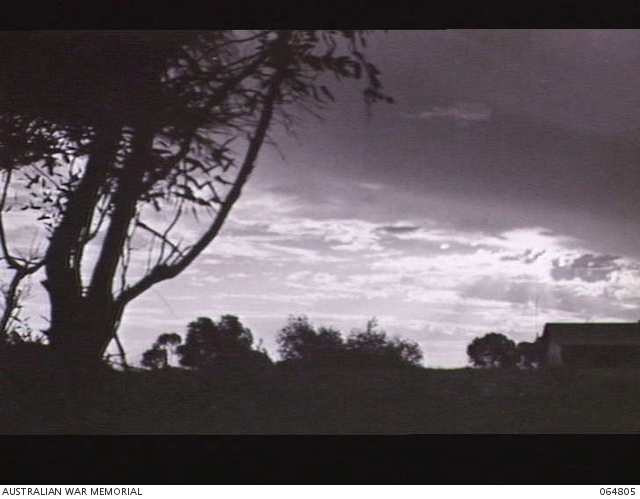 BARMERA, SOUTH AUSTRALIA. 1943-03. SUNSET OVER THE HEADQUARTERS OF THE ...