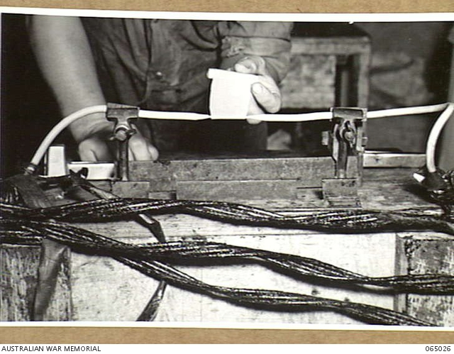 PORT KEMBLA, NSW. 1944-03-09. CABLE JOINER AT WORK ON AN UNDERSEA CABLE ...