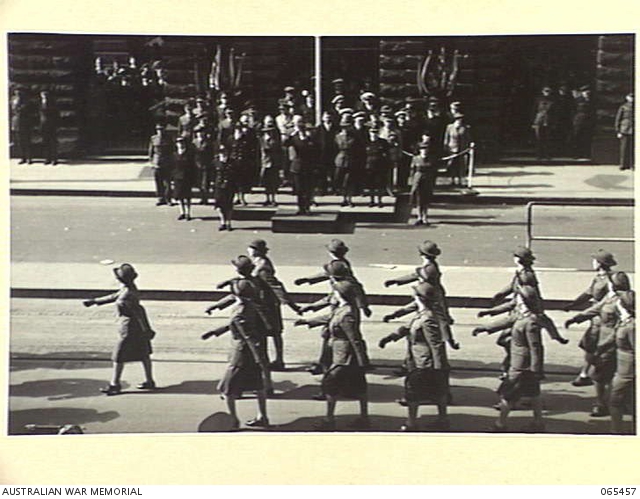 MELBOURNE, VIC. 1944-04-14. MEMBERS OF THE AWAS GIVE "EYES RIGHT" AS ...