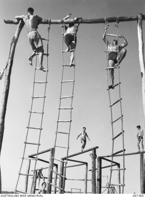BURLEIGH HEADS, QLD. 1944-07-14. TROOPS OF THE 7TH DIVISION CLIMBING ...