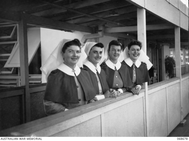 DARWIN, NT. 1944-08-21. FOUR HAPPY NURSES ON THE VERANDAH OF THE 129TH ...