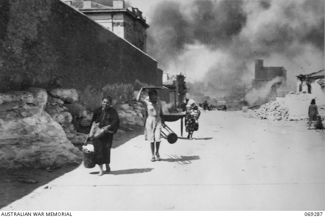 SMOKE FROM BLAZING SHIPS AND DOCKS FILLS THE SKY AS REFUGEES FLEE FROM ...