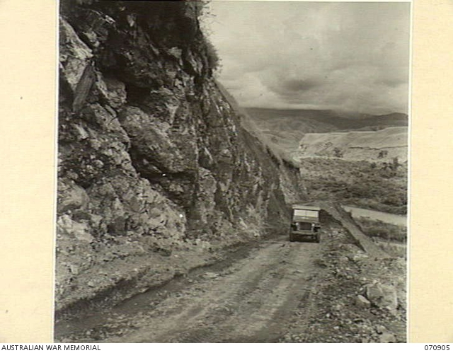 WAU - LAE ROAD, 1944-02-26. A ROAD SHELF CUT 16 FEET WIDE INTO THE SIDE ...