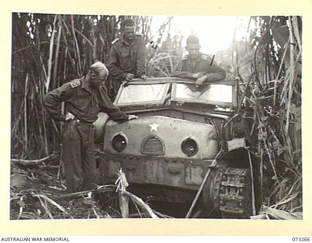 Australian officers of the 35th Infantry Battalion, examining a ...
