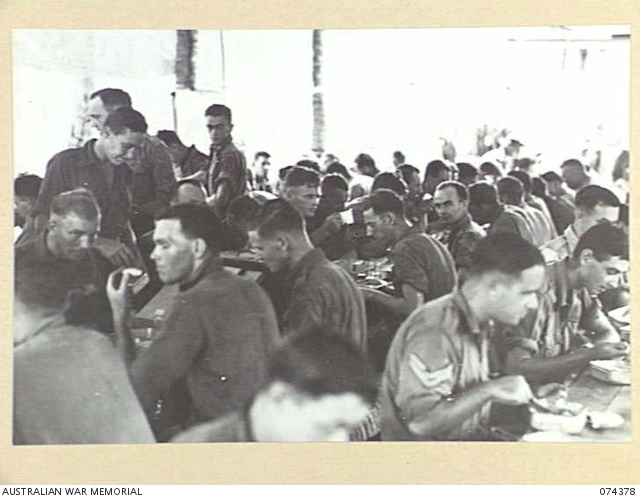 SIAR, NEW GUINEA. 1944-06-27. TROOPS ENJOYING THEIR LUNCH IN THE MESS ...
