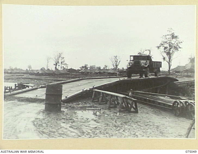 LAE, NEW GUINEA. 1944-08-09. A 3 TON TRUCK CROSSING THE NEW BRIDGE ...