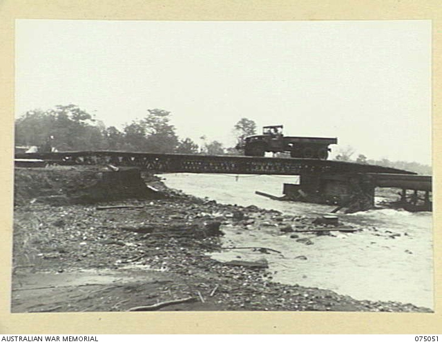 LAE, NEW GUINEA. 1944-08-09. A HEAVY ARMY TRUCK CROSSING THE NEW STEEL ...